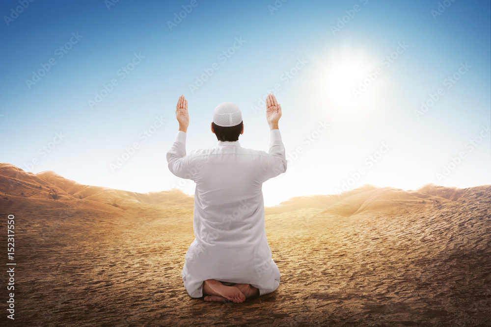 Rear view of asian muslim man sitting and praying Stock Photo | Adobe Stock