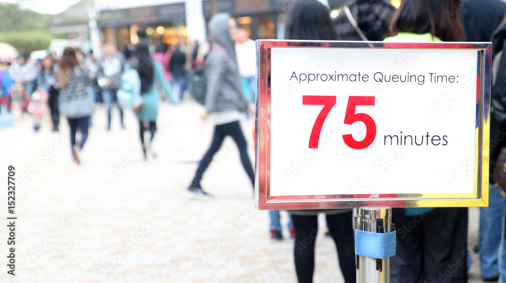 Foto Stock People waiting in a long queue, focus on the information ...