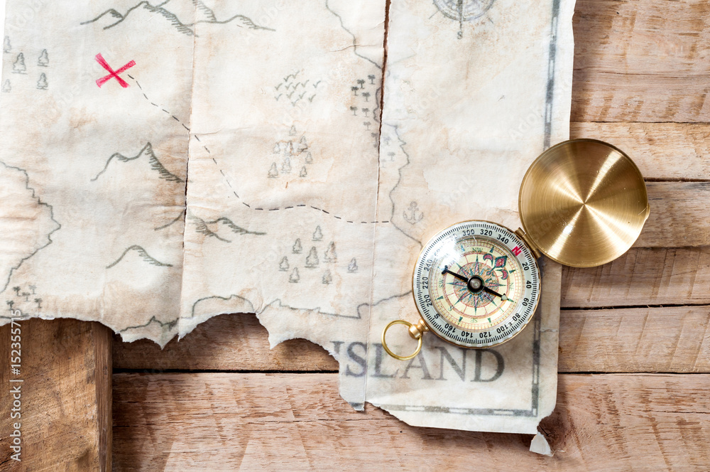 Nautical compass with fake treasure map of abstract island with red ...