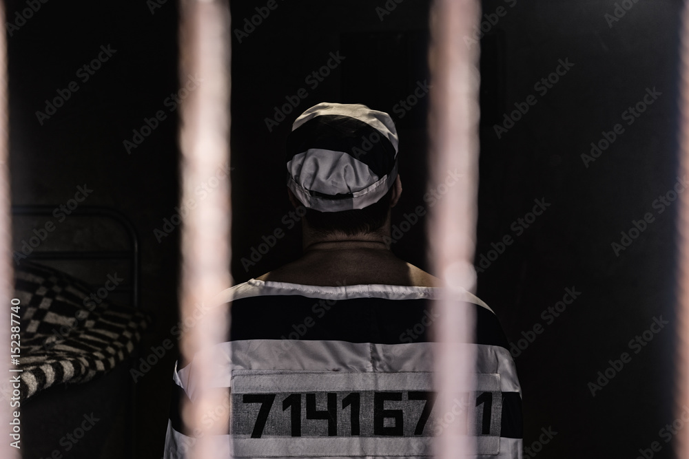 Foto de Male prisoner wearing prison uniform with sewed his number ...