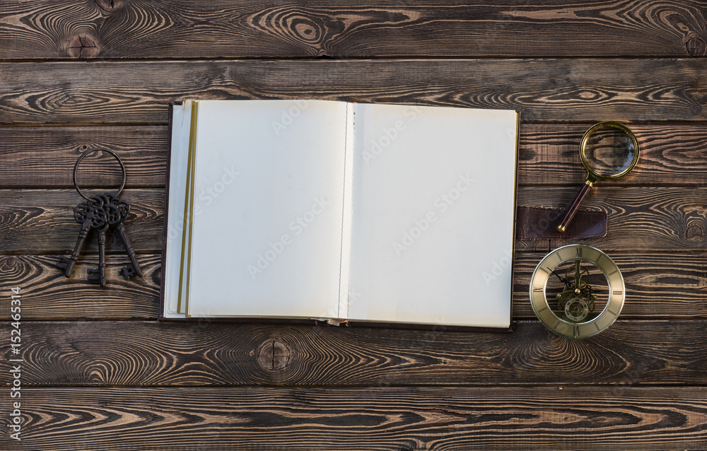 An open book, old keys, a vintage watch on an old desk Stock Photo ...