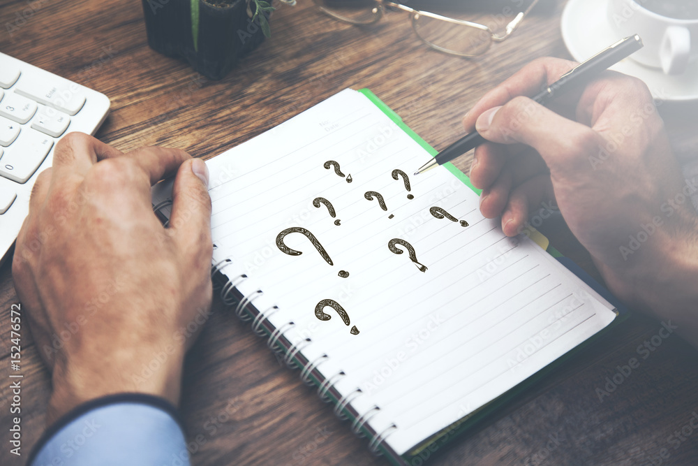 man written question mark on notepad Stock Photo | Adobe Stock