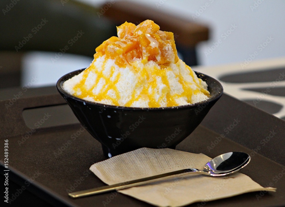 Bingsu (ice snow) topped with ripe mango, side view Bingsu is a popular ...