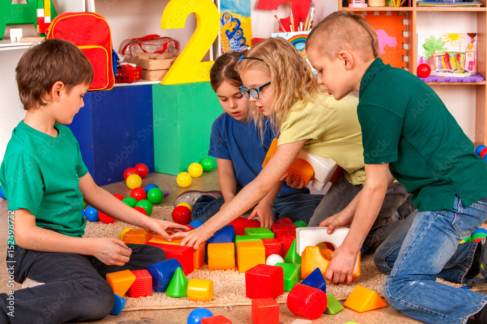 Break school of children playing in kids cubes indoor. Two girl and boy ...