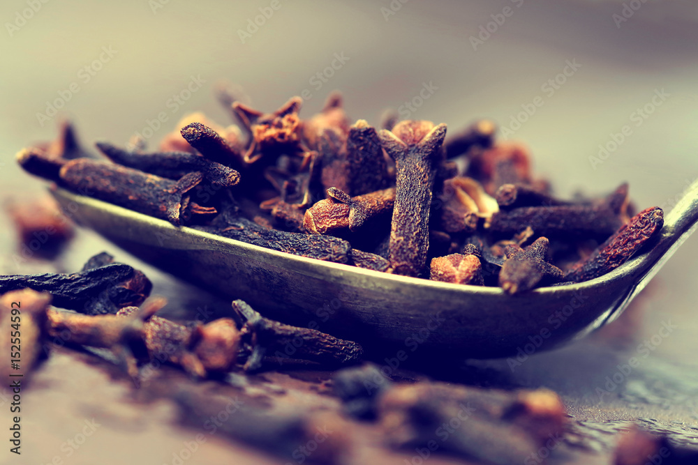 Cloves. Spice in spoon on texture background Stock Photo | Adobe Stock