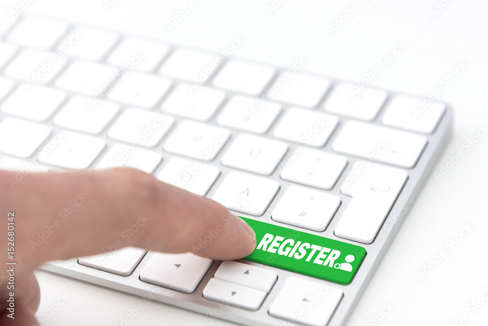 finger pressing a blue key labeled REGISTER with symbol on a computer ...