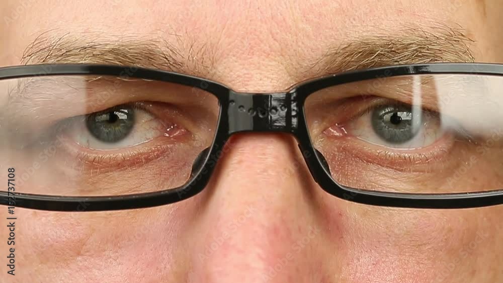 Stockvideon Adult man in eyeglasses extremely close-up view. Thinking ...