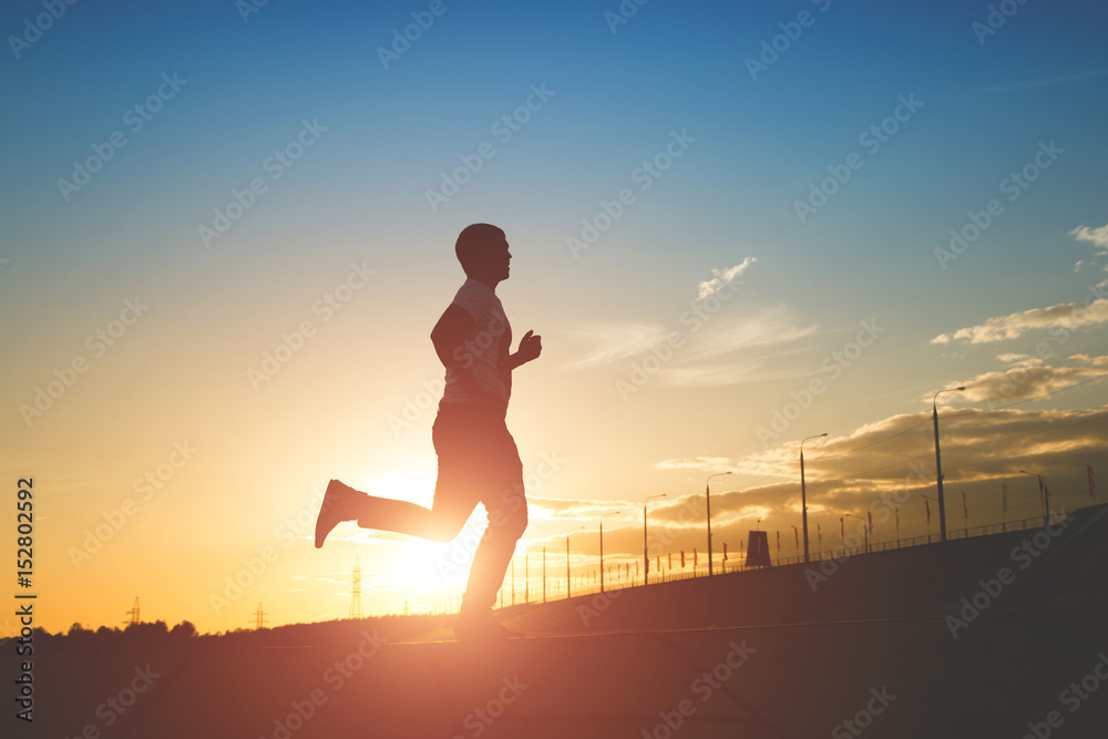 Silhouette of running man on sunset background Stock Photo | Adobe Stock