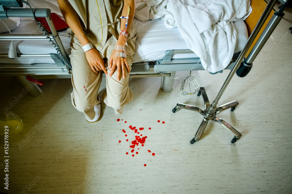 Sick patient in hospital bed with blood on floor Stock Photo | Adobe Stock