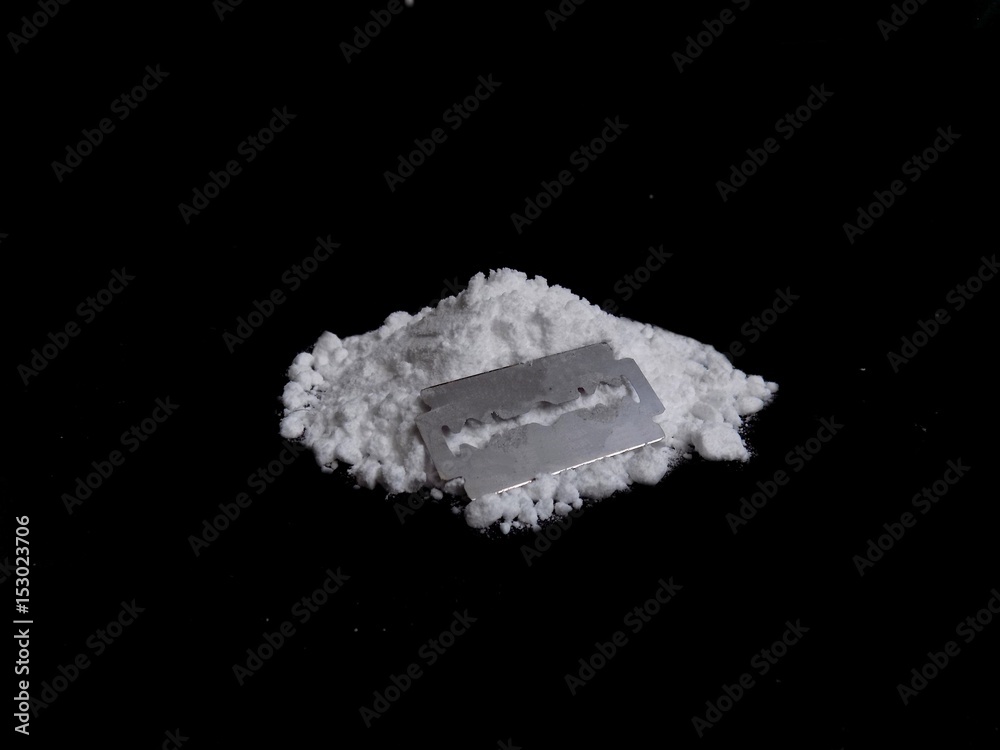 Razor blade on cocaine drug powder pile on black background Stock Photo ...