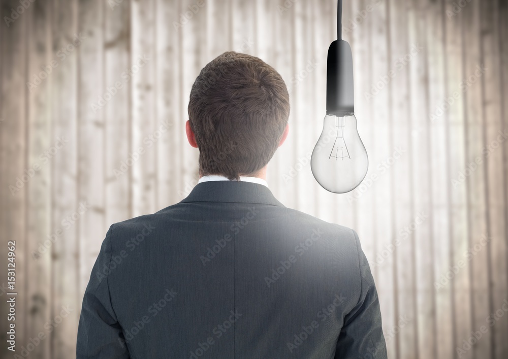 Back of Business man with glowing lightbulb Stock Photo | Adobe Stock