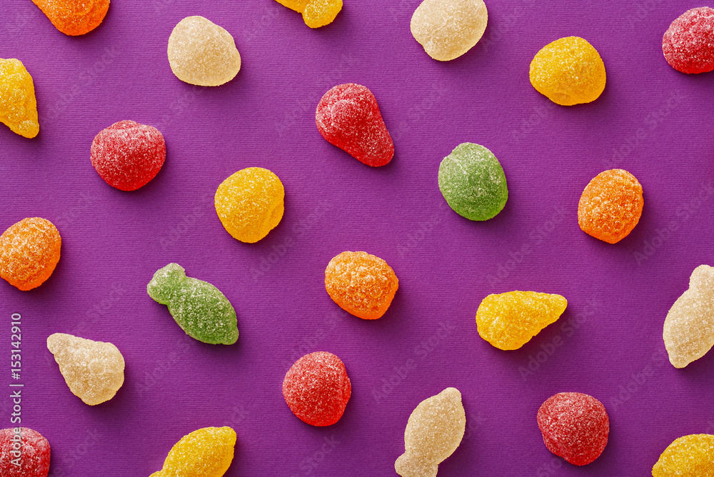 Colorful gummy candies pattern on a purple background. Soft gums in ...