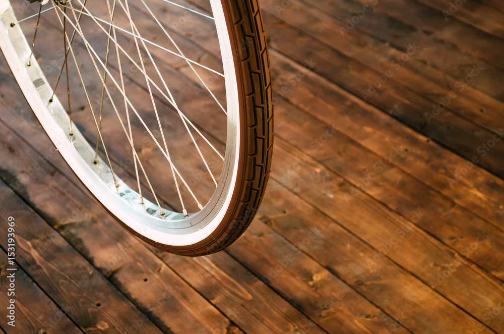 Wheel of a stylish bicycle with a white rim and a brown rubber tire on ...