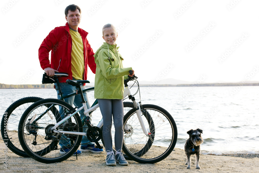 Biker family. Happy family with dog on bikes Stock Photo | Adobe Stock