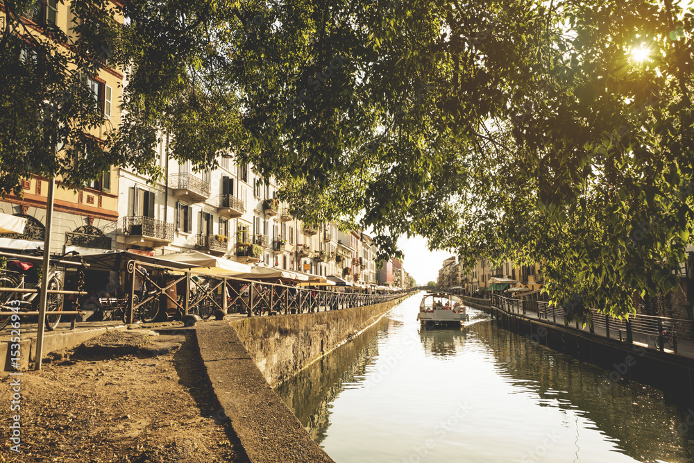 The Naviglio Grande canal waterway in Milan, Italy, at sunset. This ...