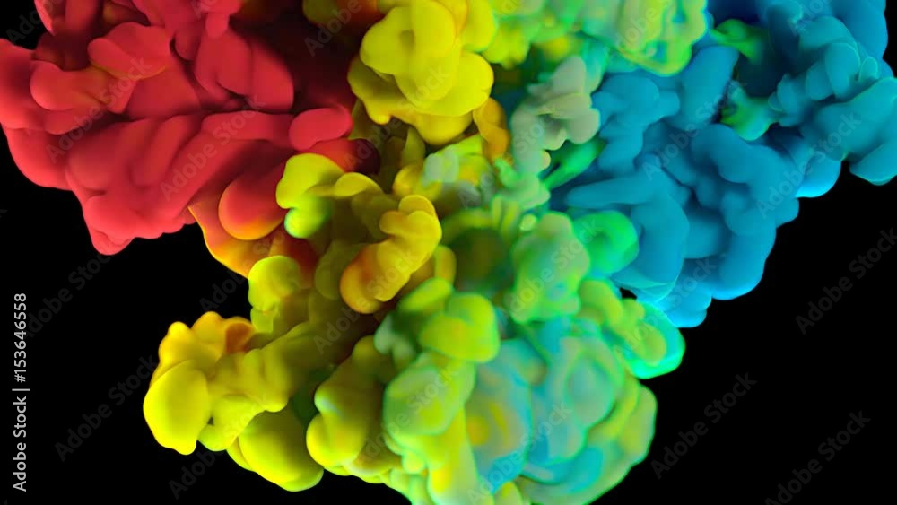 Colorful rainbow paint drops from above mixing in water. Ink swirling ...