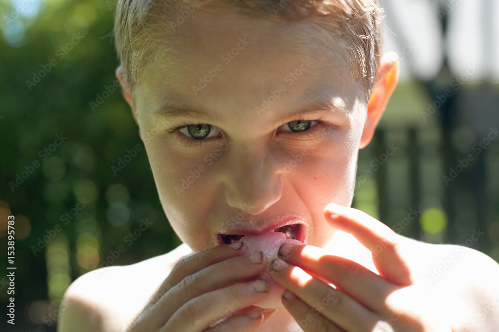 Boy biting into food Stock Photo | Adobe Stock