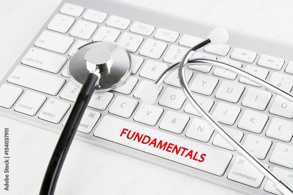 Fundamentals word with stethoscope on keyboard against white background ...
