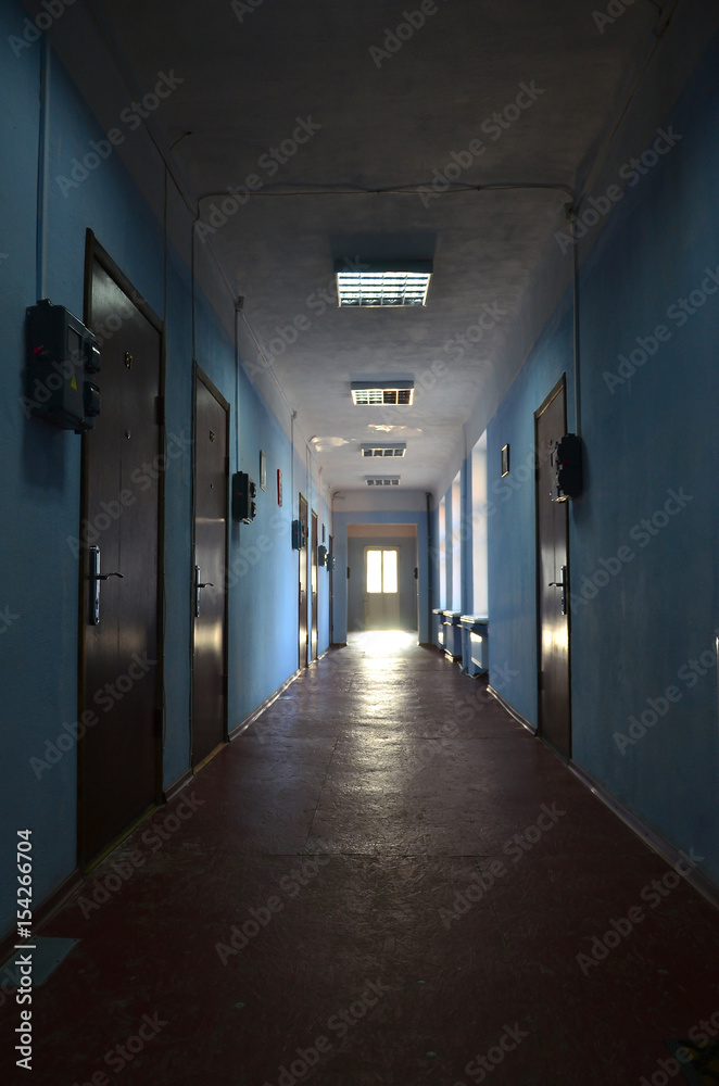 The gloomy corridor of a neglected public building. Public space in a ...