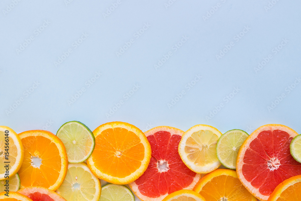 Various fresh citrus fruits on the blue background with copy space. Top ...