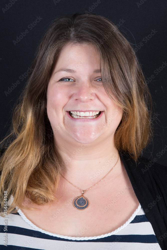 fat smiling woman portrait in black background Stock Photo | Adobe Stock