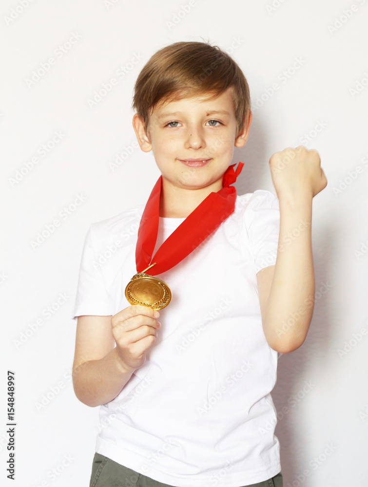 Cute blonde boy with gold medal winner Stock Photo | Adobe Stock
