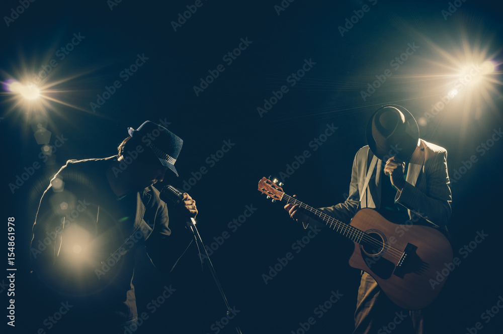 Musician Duo band hand holding the microphone and singing a song and ...