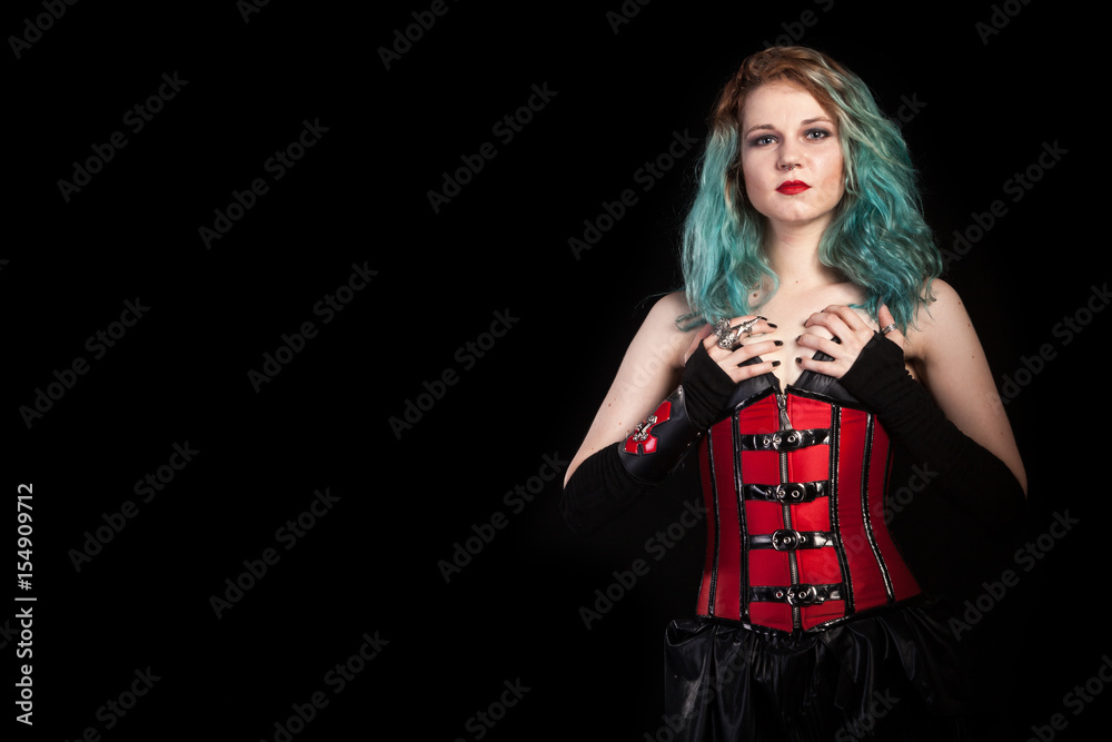 Alternative Woman In Fetish Red Leather Corset On Black Background In