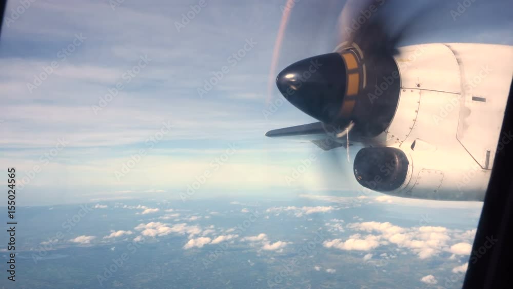 View through an airplane window on the sky and clouds vwith airplane ...