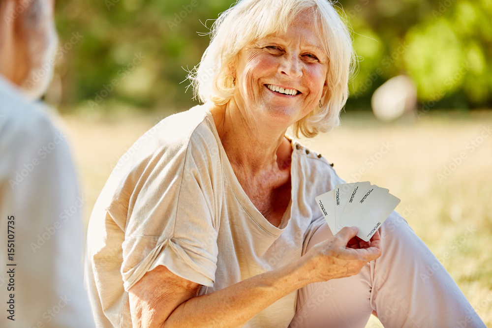 Old woman winning the card game and having fun Stock Photo | Adobe Stock