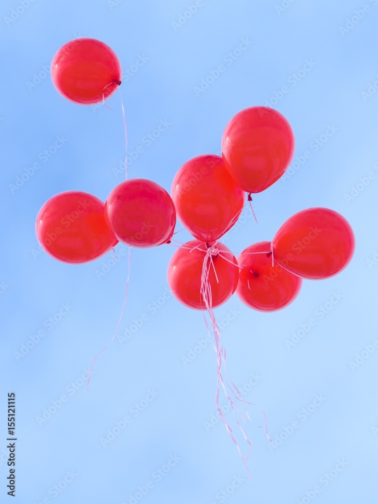 Red balloons flying in the sky. Stock Photo | Adobe Stock