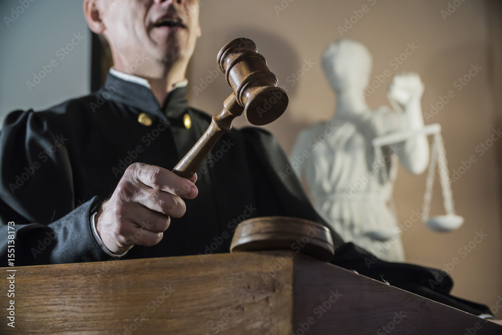 a judge with a hammer in his hand in the court room Stock Photo | Adobe ...