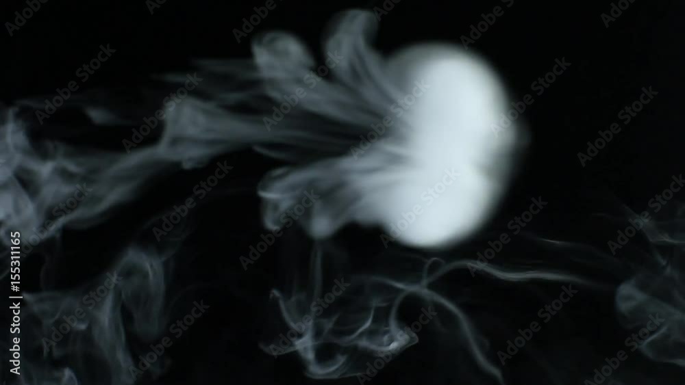 Vapor like smoke on a dark black background. Vape smoke rings in motion ...