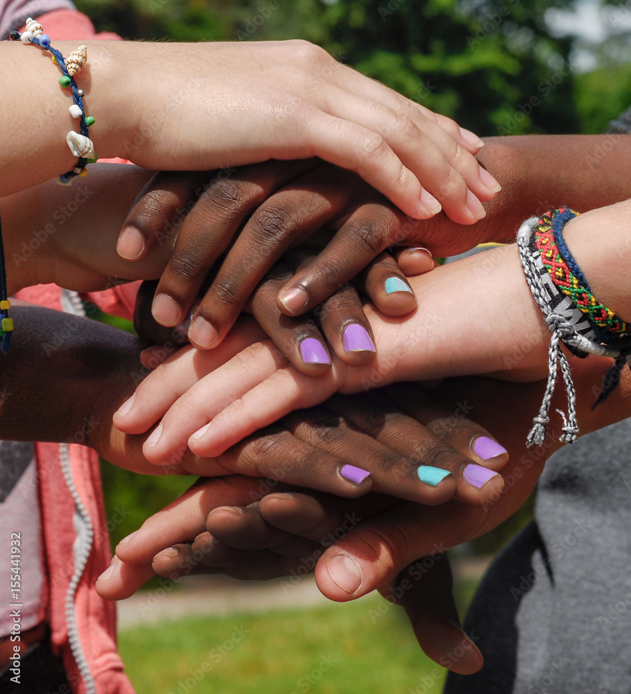 Multiracial teenagers joining hands together in cooperation Stock Photo ...