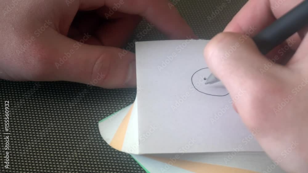 the hand of the young man draws a sad face,then crossed out,tears off ...