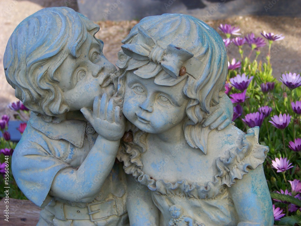 Boy Whispering to Girl Statue in Fairy Garden Stock Photo | Adobe Stock