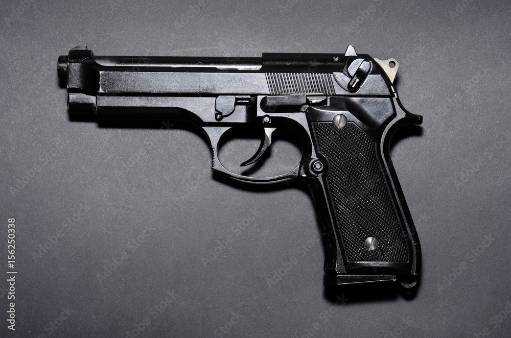 Used black metal 9mm pistol gun on black background Stock Photo | Adobe Stock