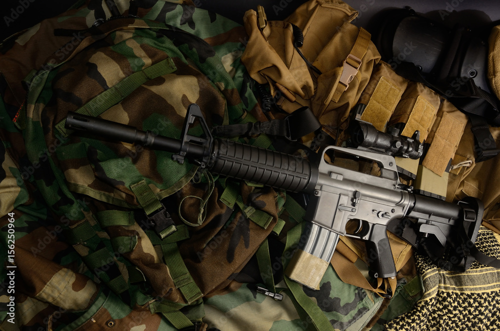 Assault rifle, pistol, grenade with tactical chest rigs and ammunition ...