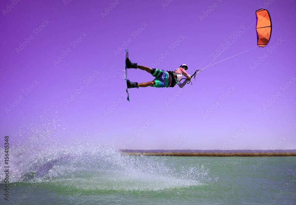 Professional kite boarding rider sportsman jumps high acrobatics ...