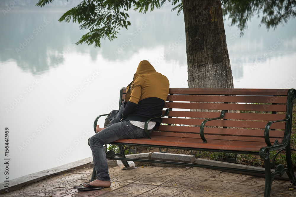 Lonely man lying on the bench Stock Photo | Adobe Stock