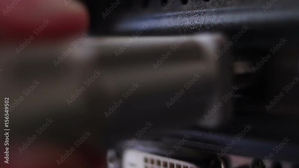 DVI connector on graphics card, Hand connects plugs in a DVI ...
