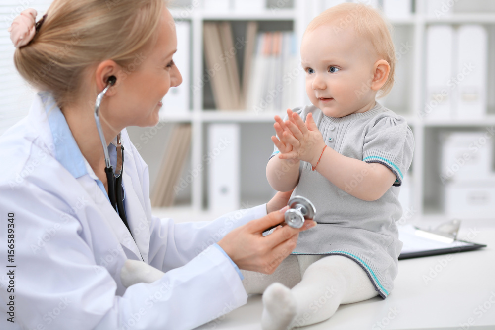 Pediatrician is taking care of baby in hospital. Little girl is being ...