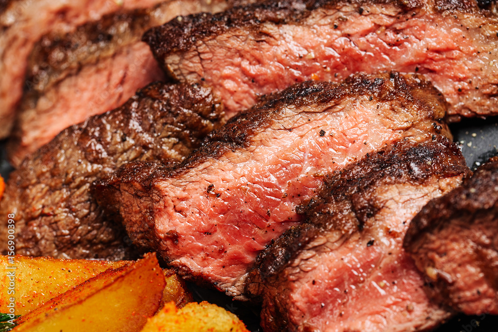 Beef rump steak from marble beef medium rare with potatoes and sauce on ...