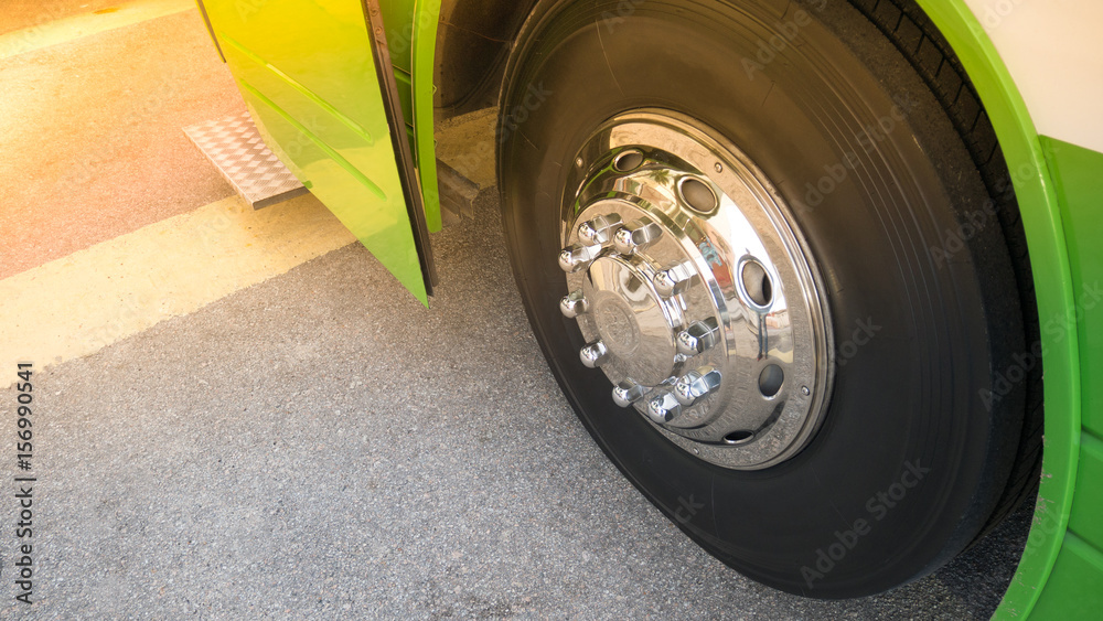 Side view of the green travel bus with door and bus wheel and copy ...