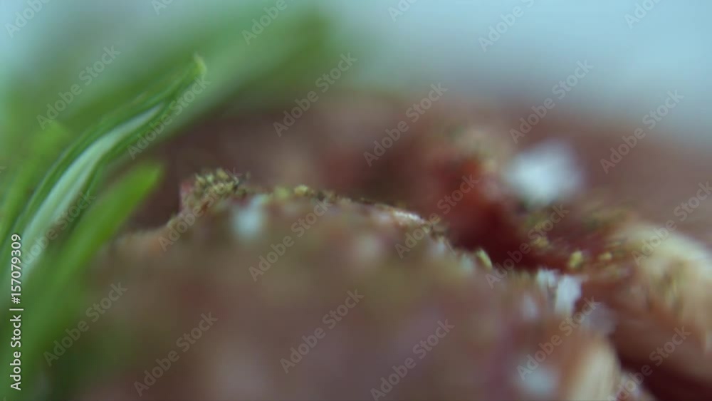 Camera follows spices flying after being exploded against white ...