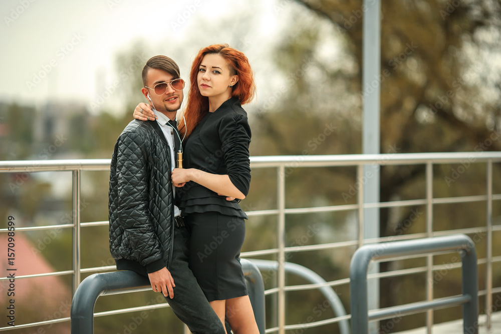 Couple in love. Modern haircuts. Handsome guy in headphones and pretty ...
