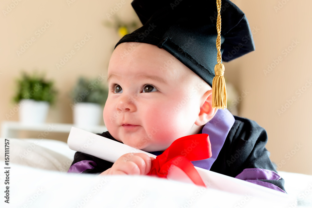 Baby girl in graduation cap and gown Stock Photo | Adobe Stock