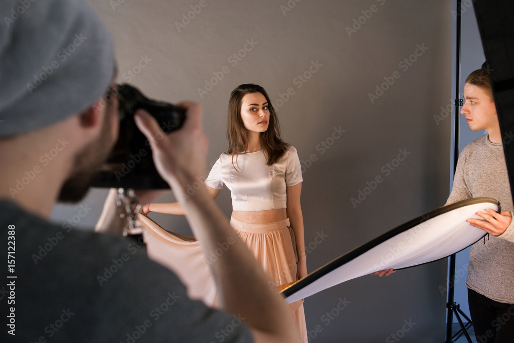 Model on photo session posing to photographer. Unrecognizable man ...