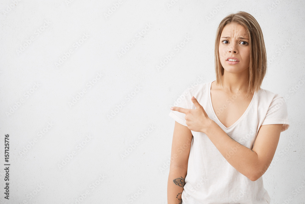 Pretty girl with bob hairstyle looking at camera having scared or ...