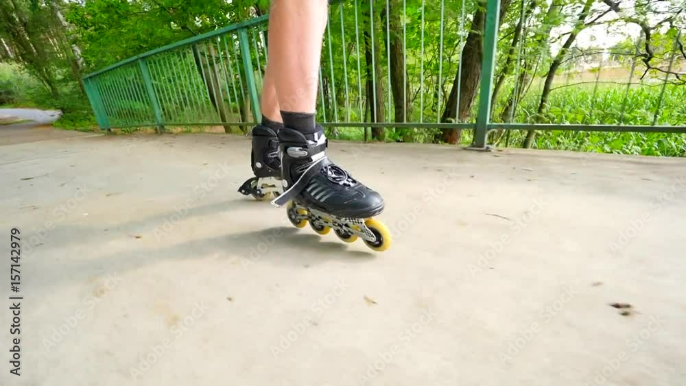 Front close view to inline skates riding on the bridge . Outdoor inline ...